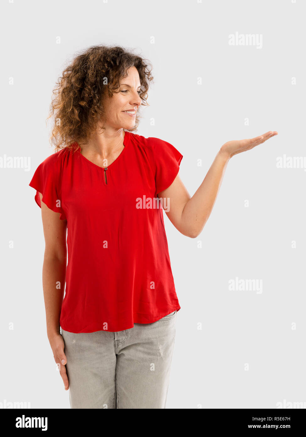 Happy woman showing something Stock Photo - Alamy