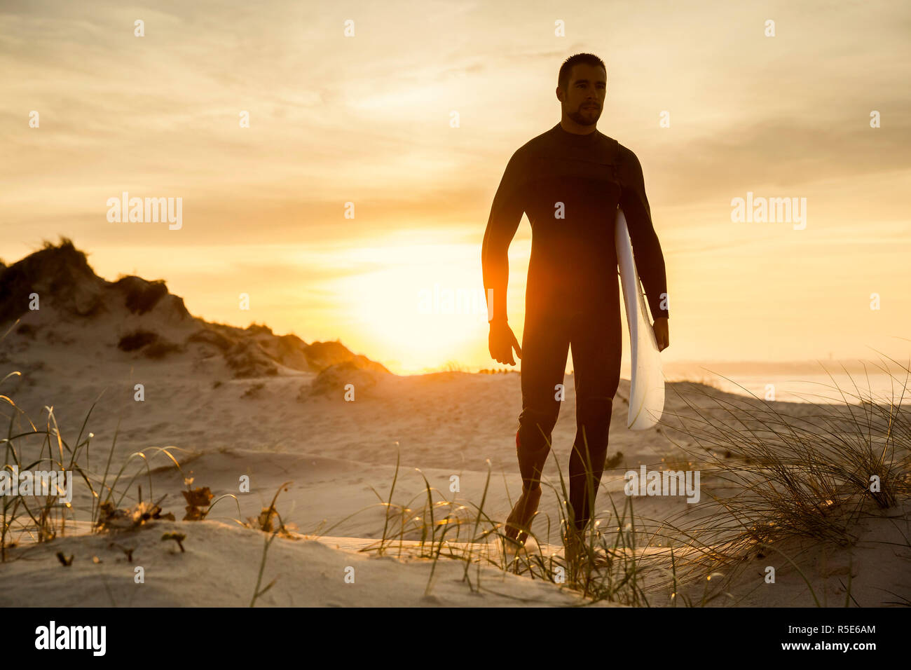 A surfer with his surfboard Stock Photo - Alamy