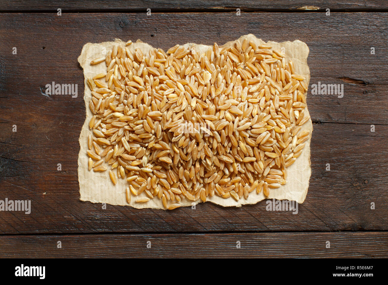 Pile of Kamut grain on wooden background Stock Photo - Alamy