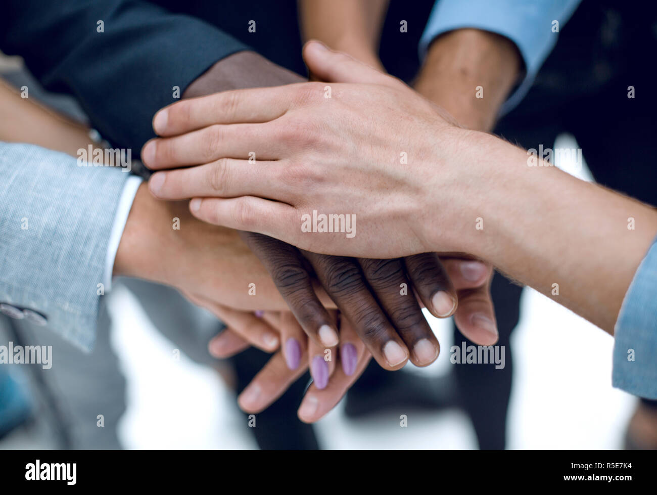 Many hands stacked hi-res stock photography and images - Alamy