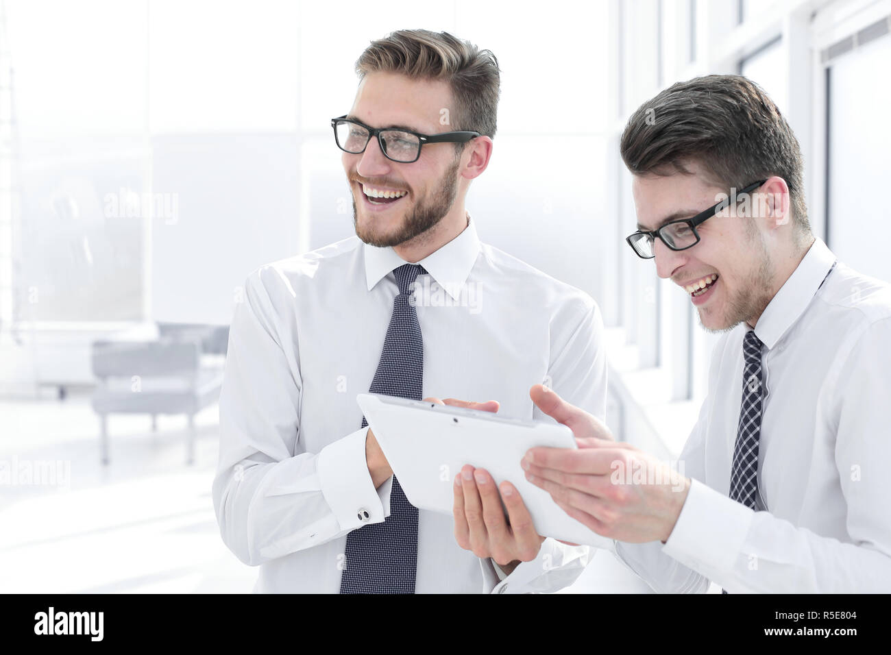 close up.cheerful employees looking at the digital tablet screen Stock ...