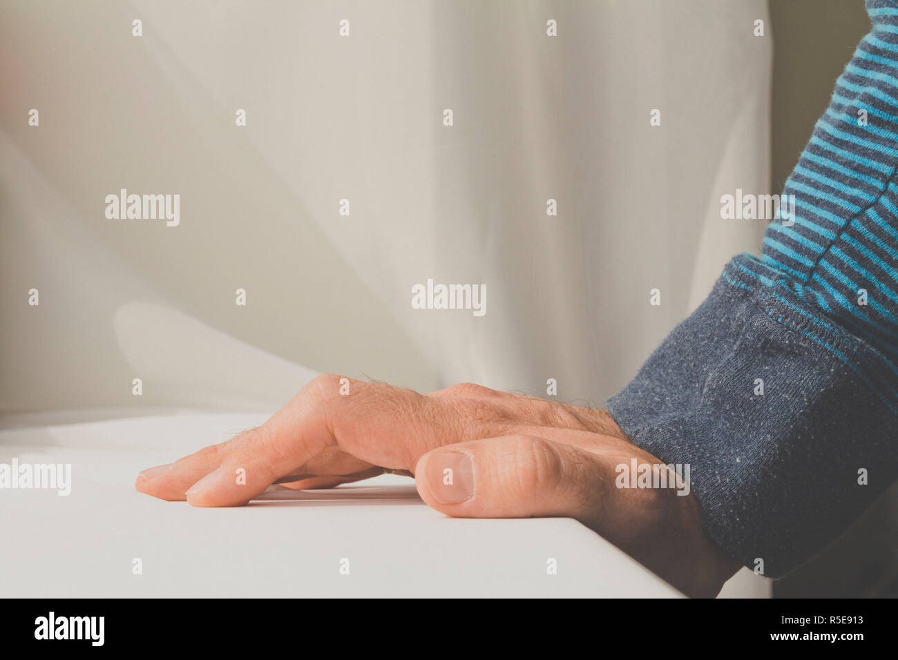 Man leaning and puts his hands down on white cloth background Stock ...