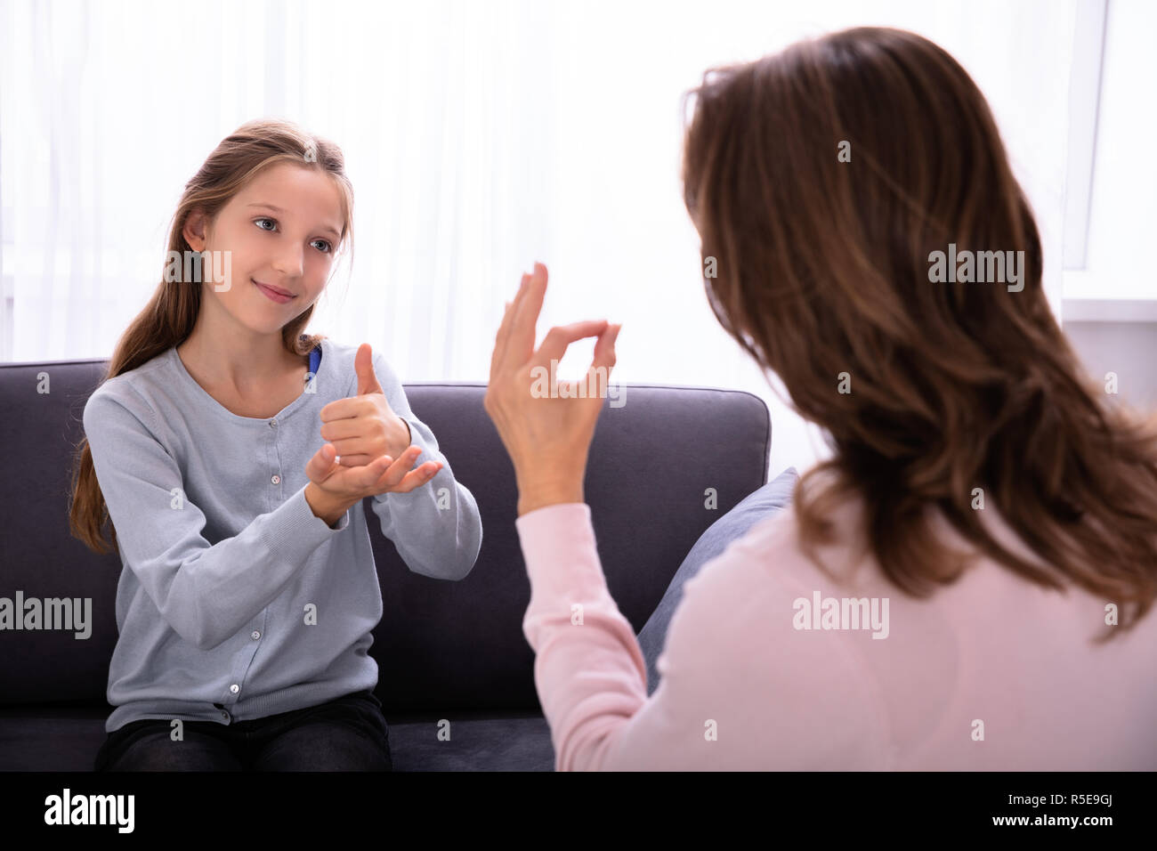 Deaf children learning sign language hi-res stock photography and ...