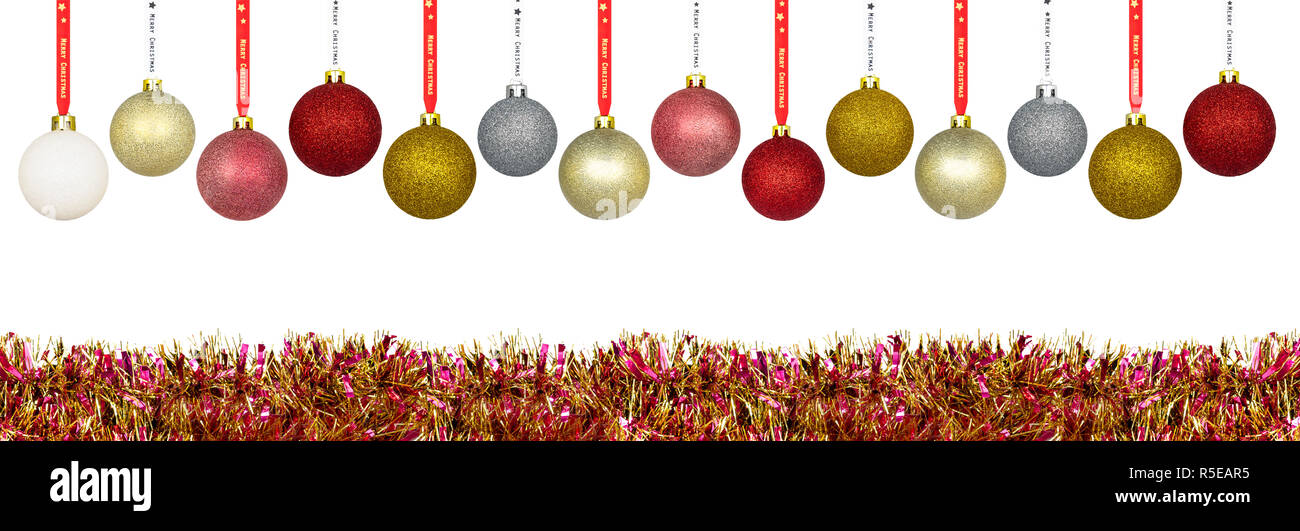 A lot of colorful Christmas baubles hanging on a ribbon over a colorful ...