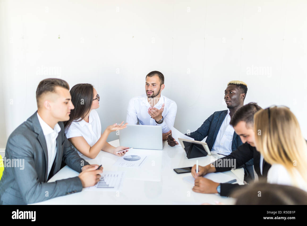 Successful team leader and business owner leading informal in-house ...