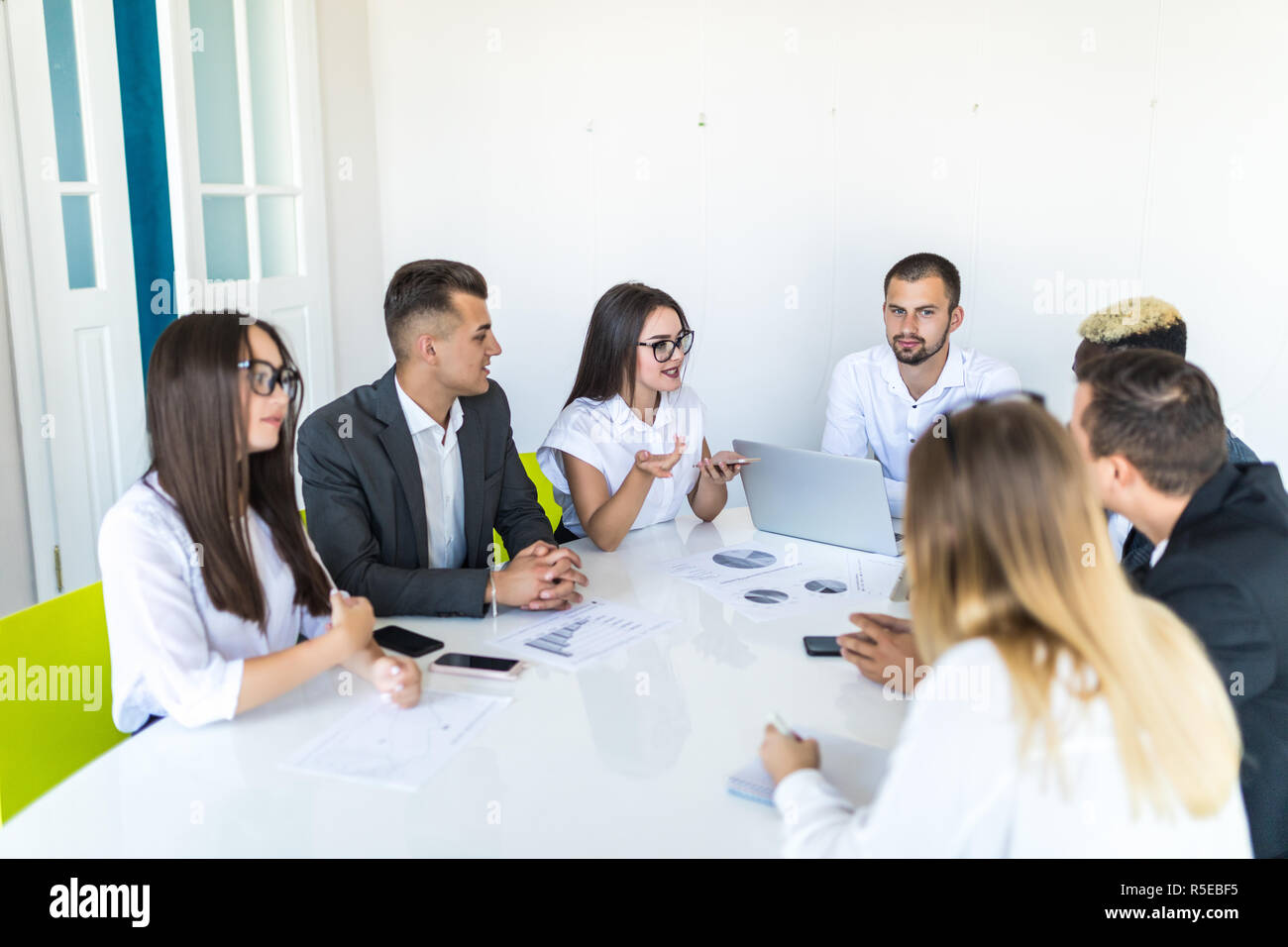 Business people discussing the charts and graphs showing the results of ...