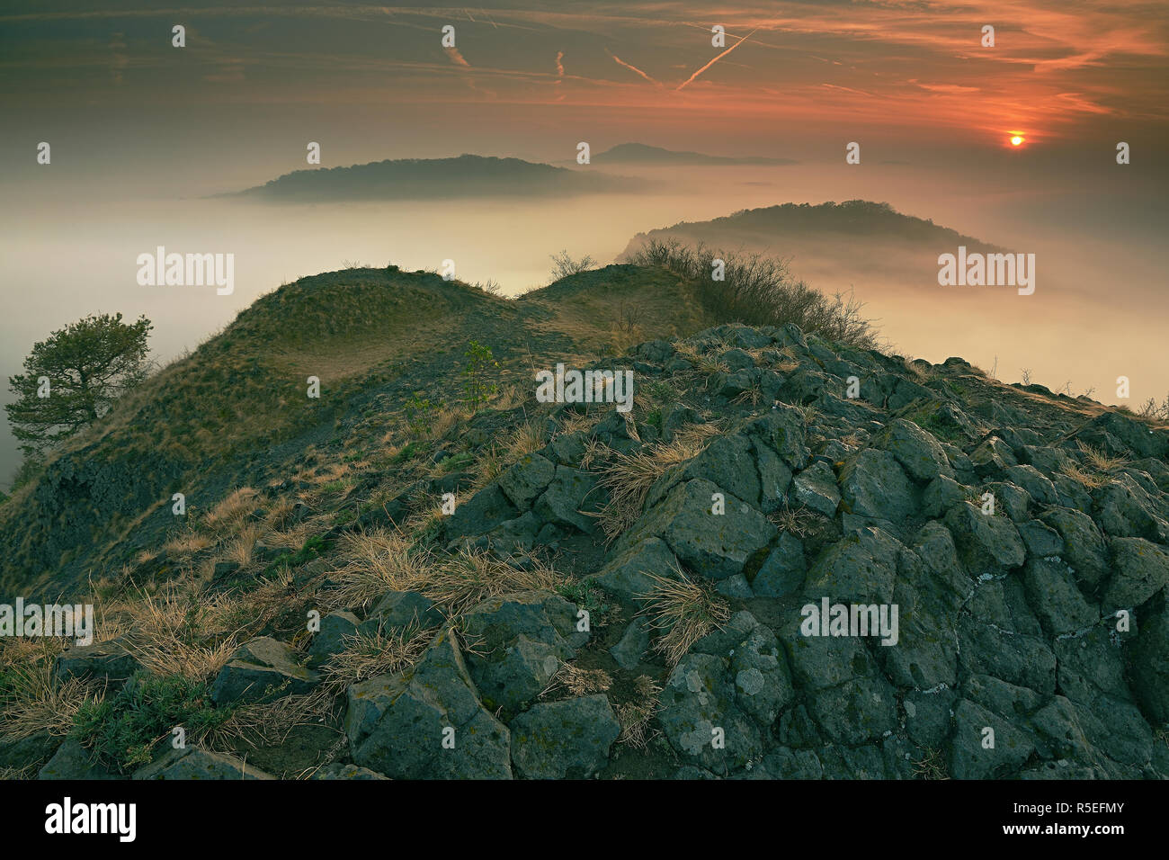 The rocky peak with daybreak. Full moon night ends and sun appeared in ...