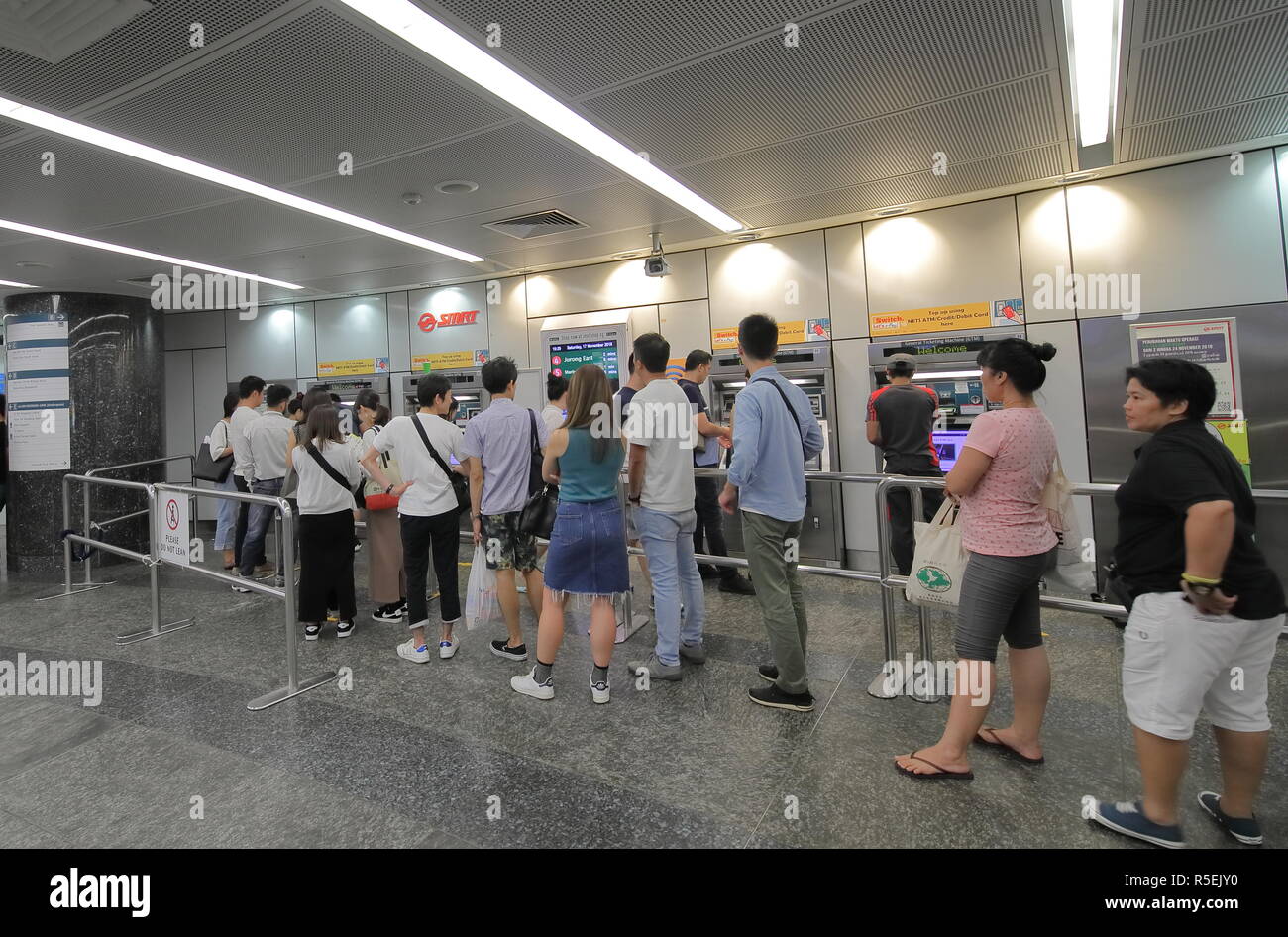 People queue for ticket machine at Orchard road MRT station Singapore ...
