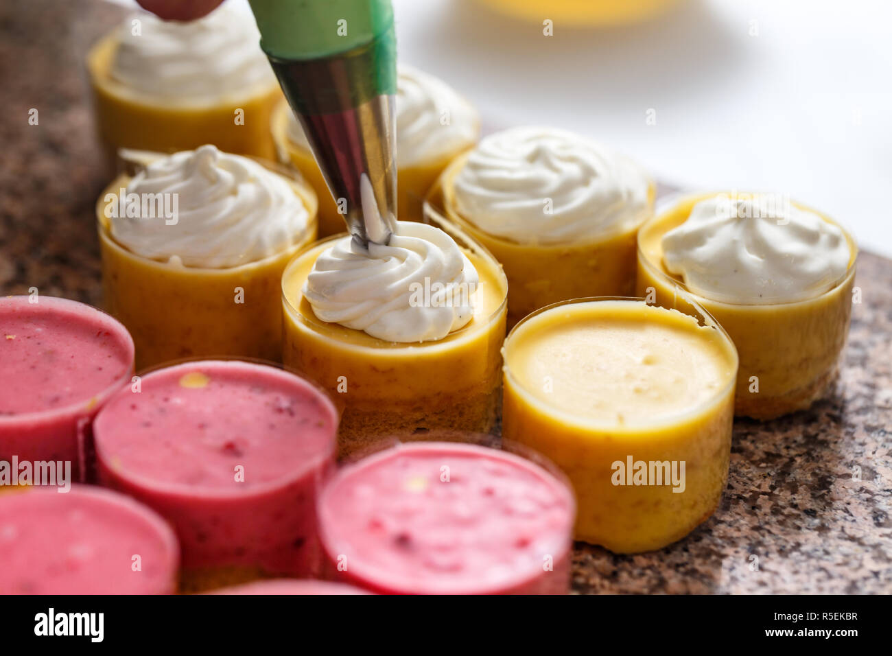 Pastry chef decorating mini cake hi-res stock photography and images ...