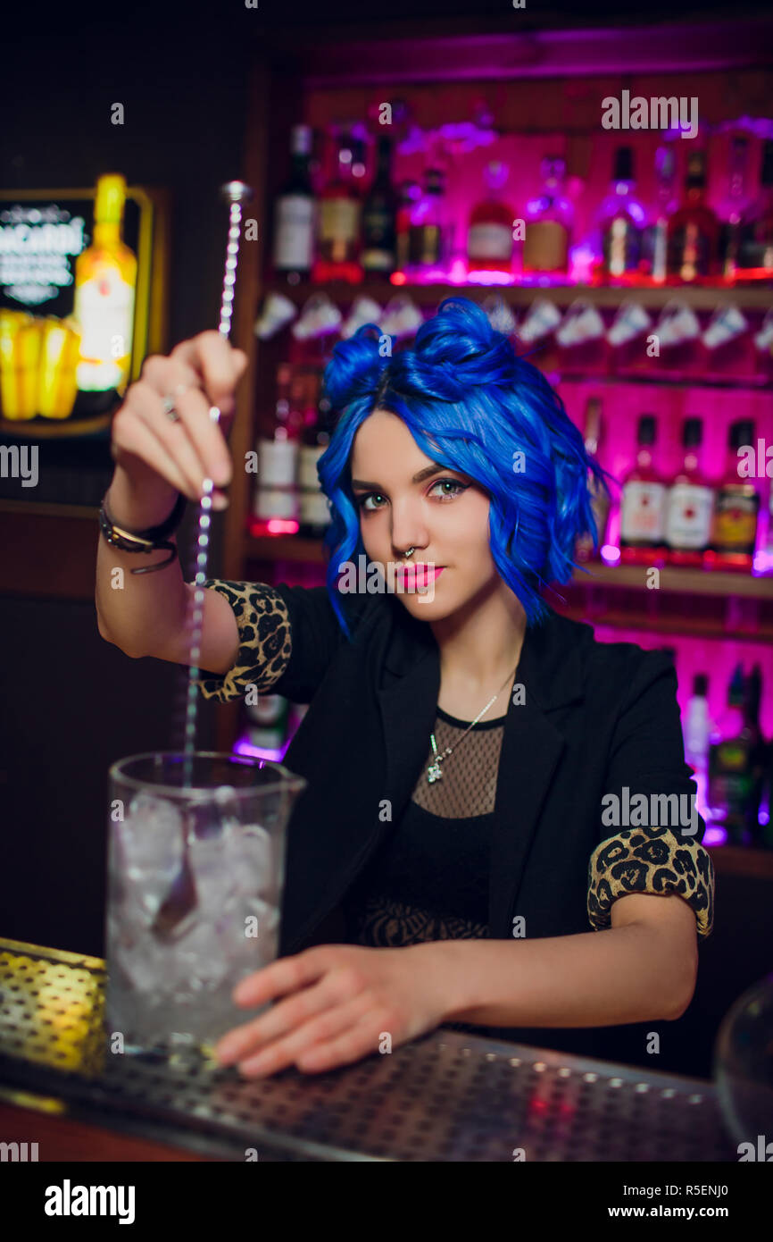 bartender girl with blue cocktail hair on background bar Stock Photo ...