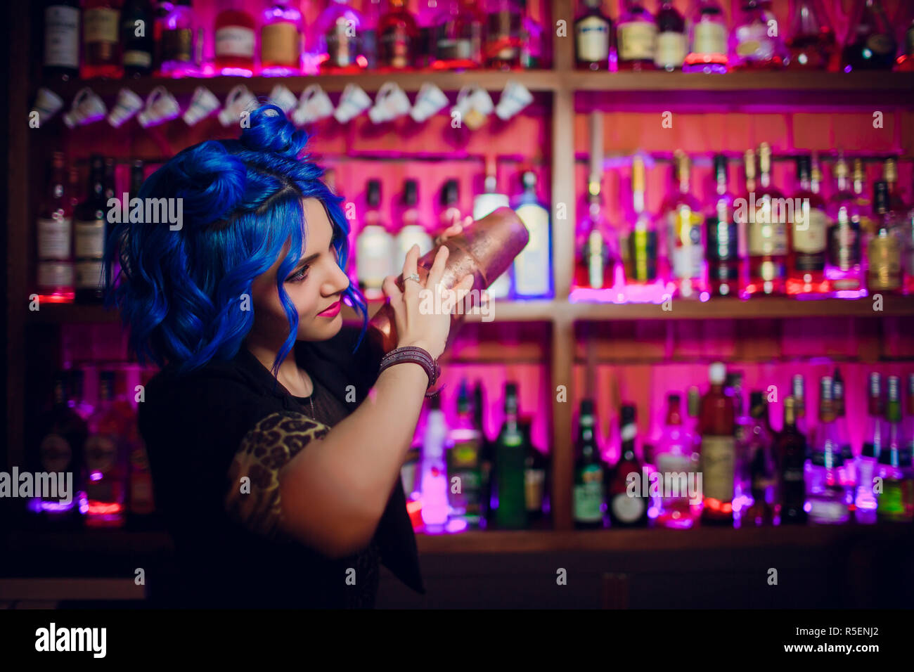 bartender girl with blue cocktail hair on background bar Stock Photo ...