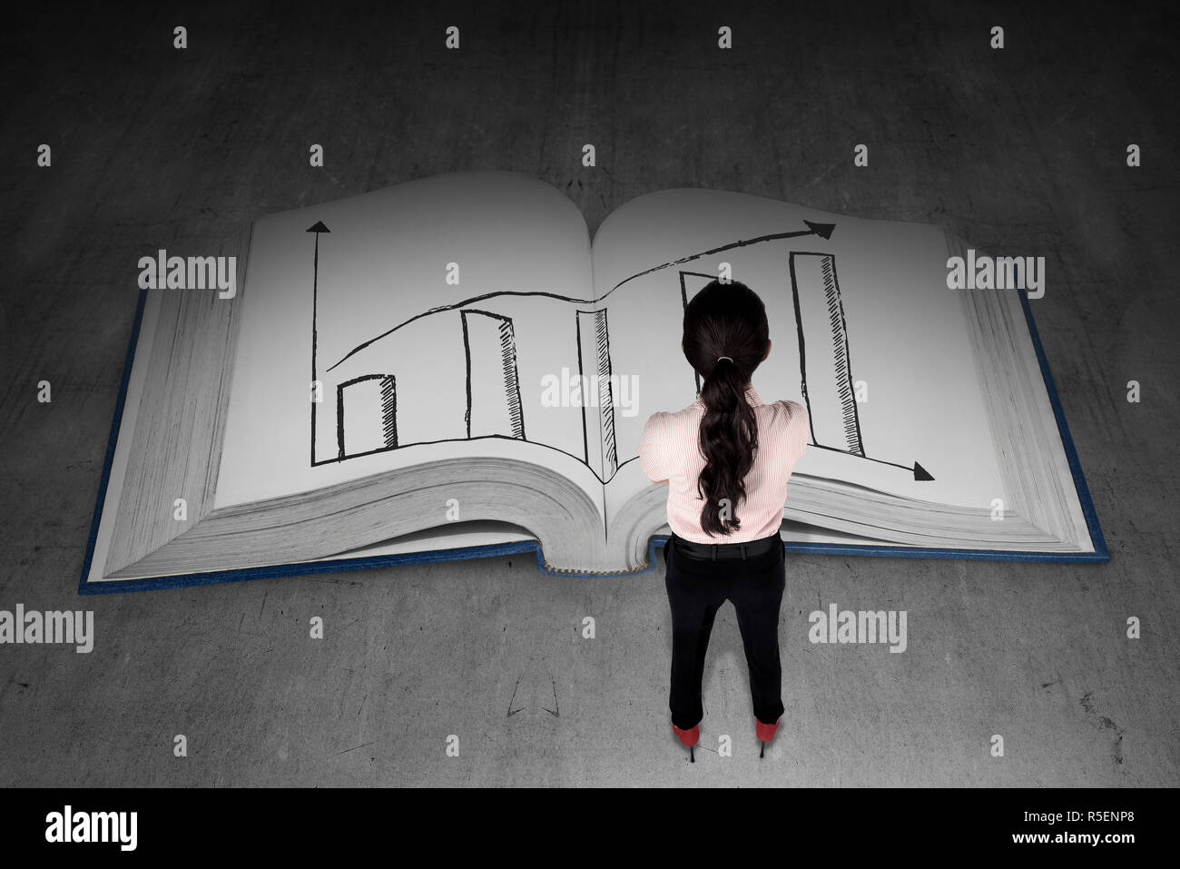 Business person looking book with rising chart page Stock Photo - Alamy