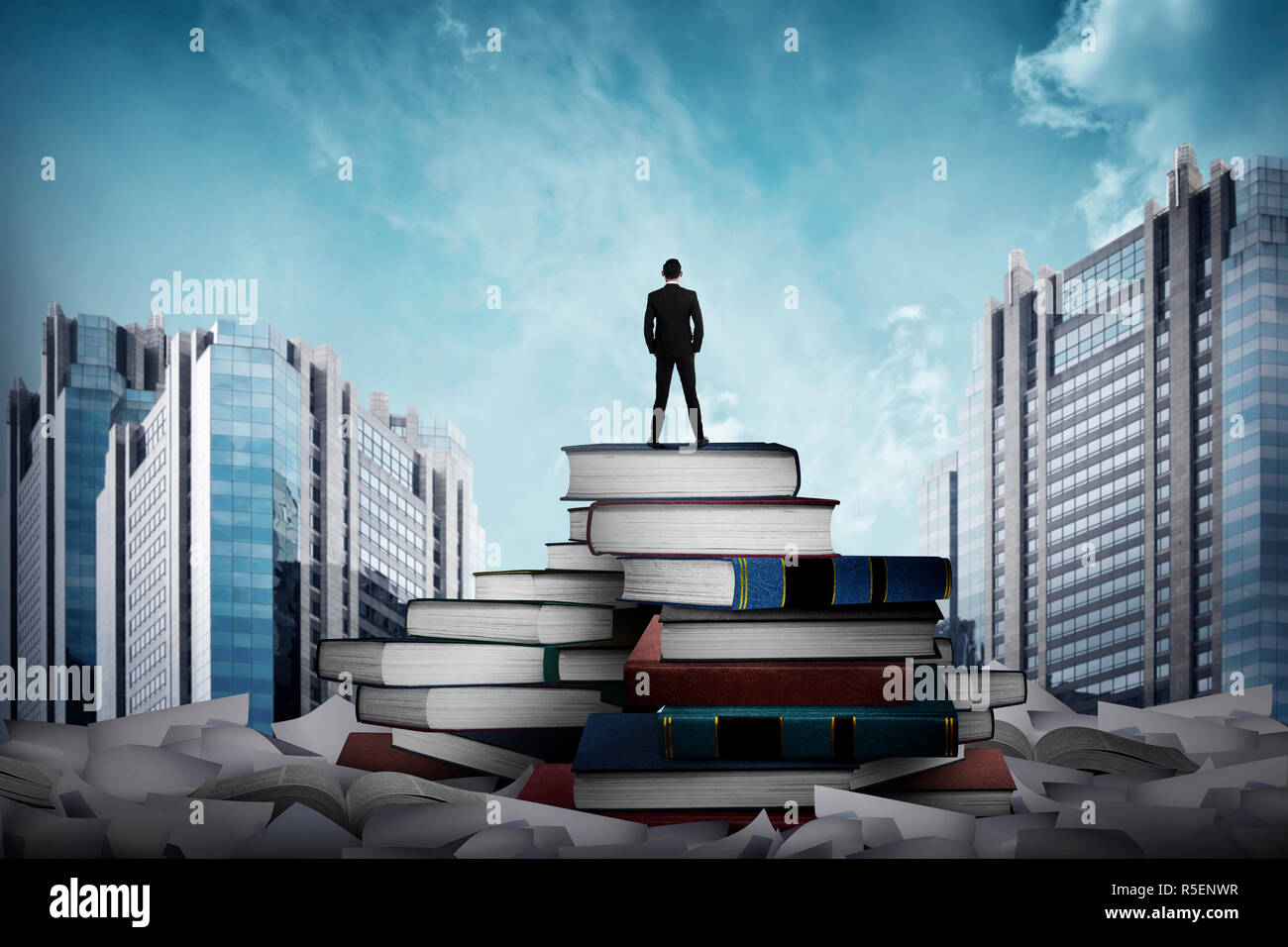 Business man standing on the top of books Stock Photo - Alamy