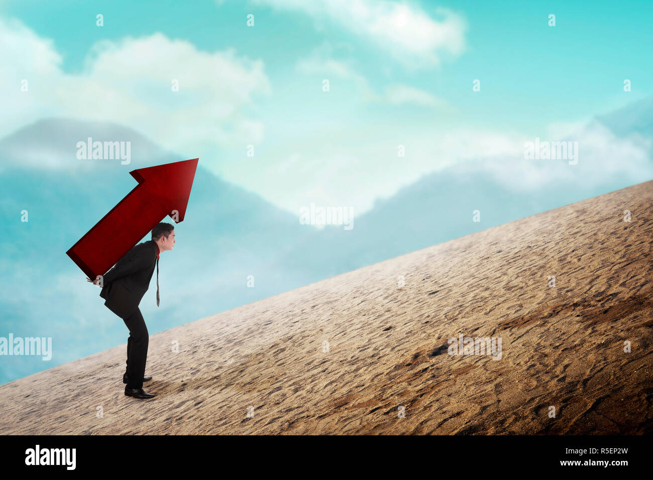 Asian business man carry big red arrow on his back Stock Photo - Alamy