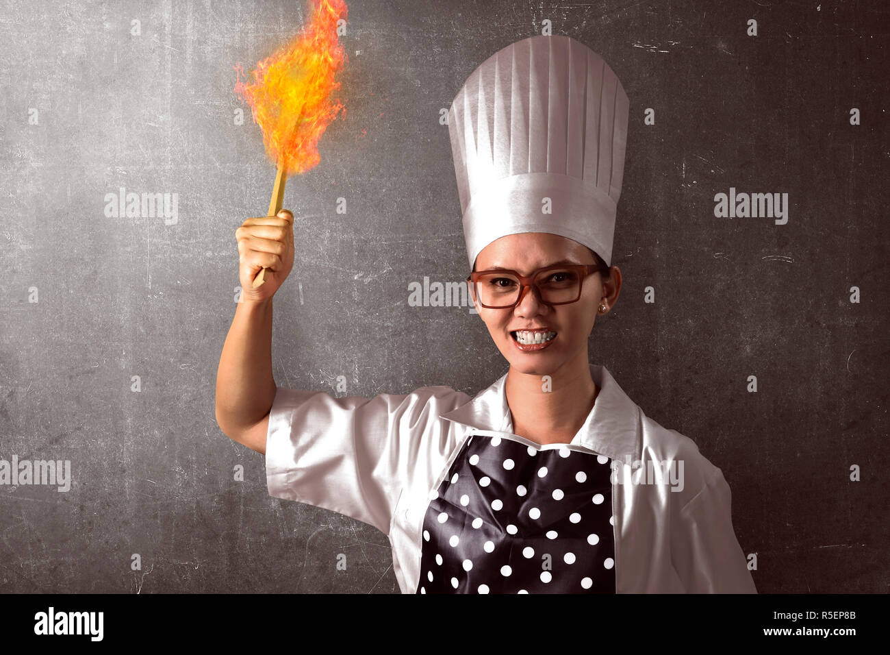 Portrait of angry young woman chef Stock Photo - Alamy