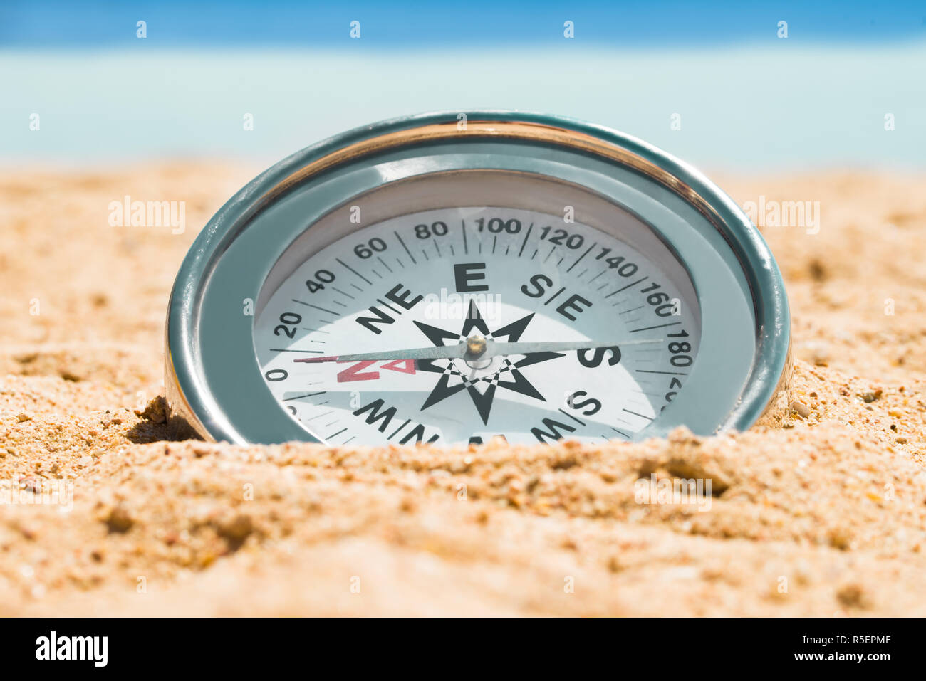 Magnetic Silver Compass On Sand Stock Photo - Alamy