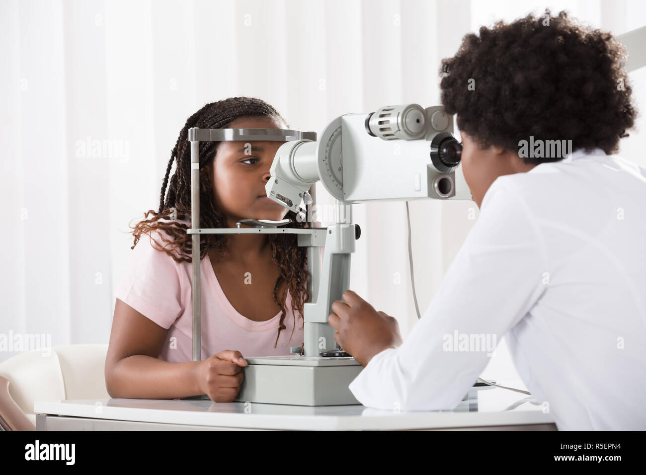 Female Optometrist Examining Patient Stock Photo - Alamy