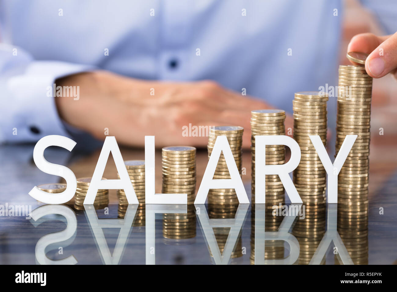 Salary Text In Front Of Coins Stack Stock Photo - Alamy