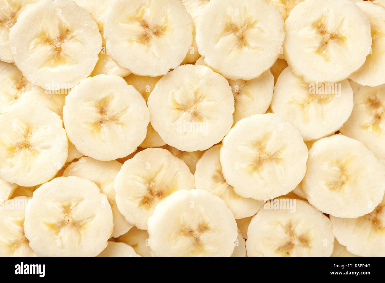 Background of ripe sliced banana slices, closeup. Food backdrop from ...