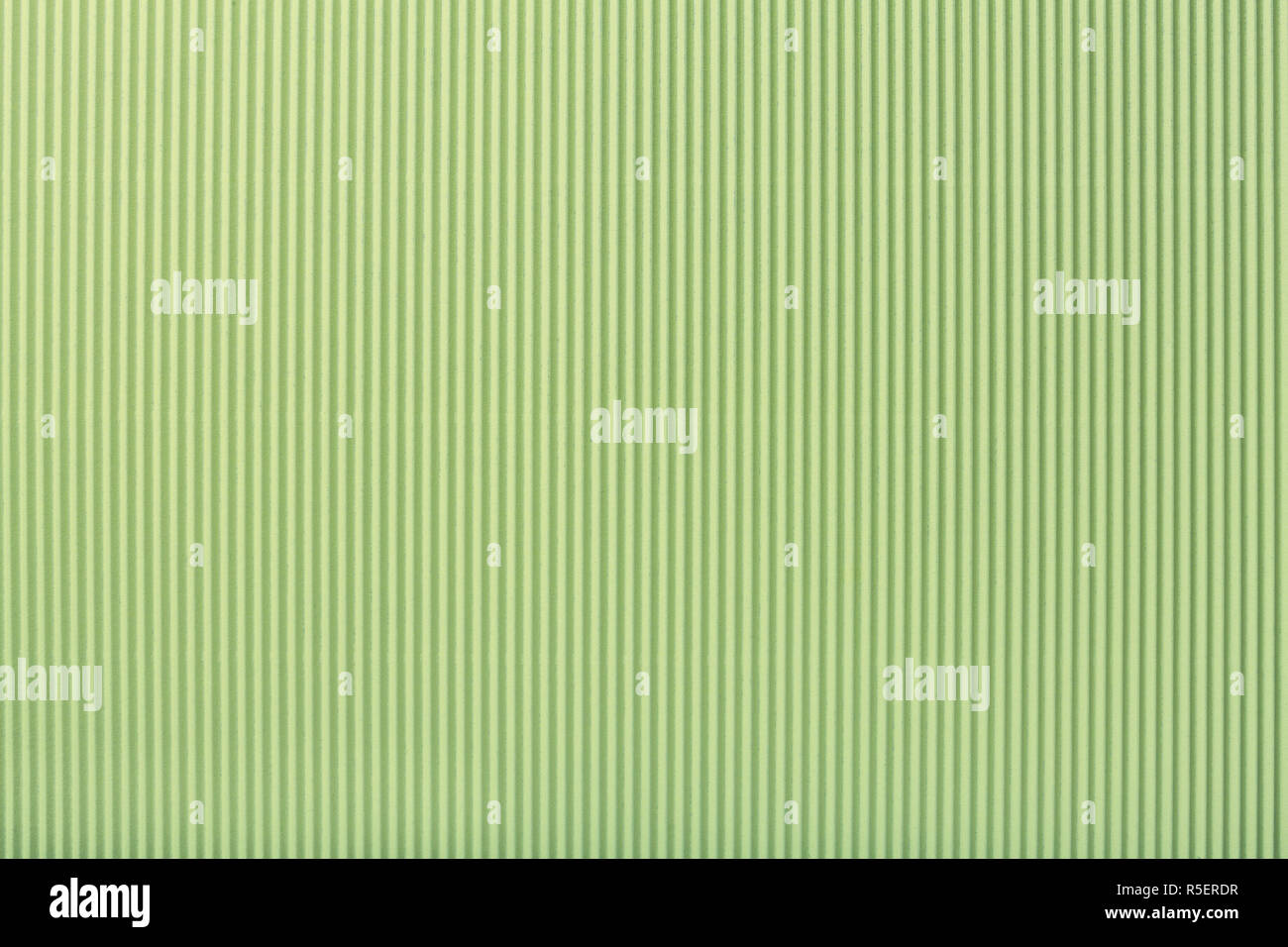 Texture of corrugated light green paper, macro. Striped pattern of ...