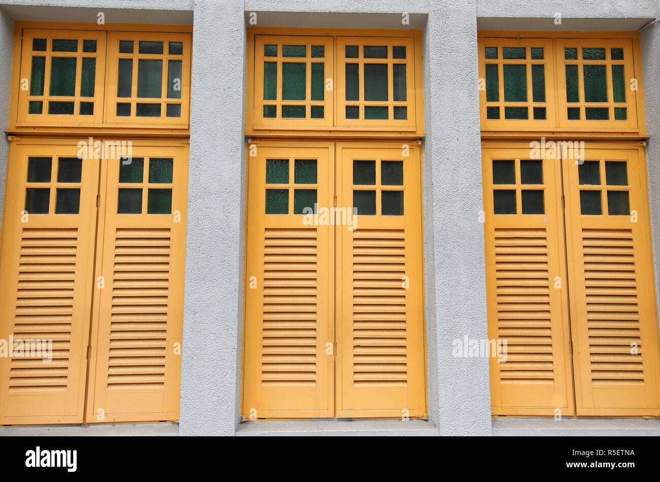 Yellow window shutters background Stock Photo - Alamy