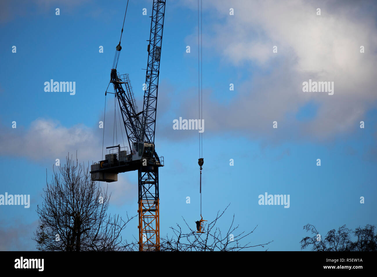 Construction site tower crane over building development Stock Photo - Alamy