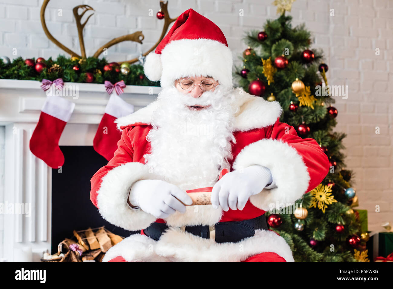 santa claus holding rolled parchment with wish list Stock Photo - Alamy