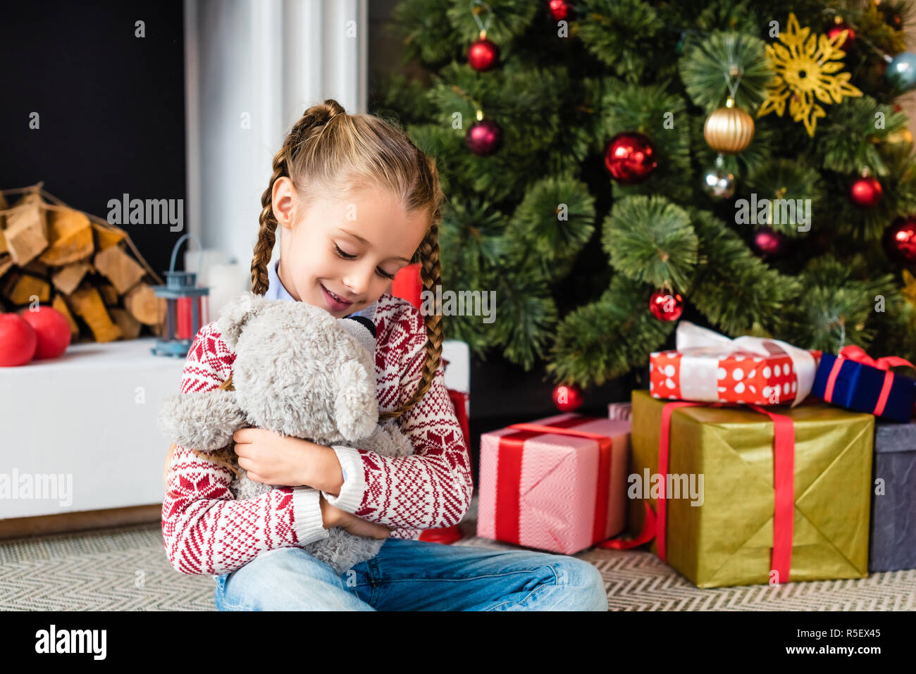 adorable happy kid playing with teddy bear at christmas eve Stock Photo ...