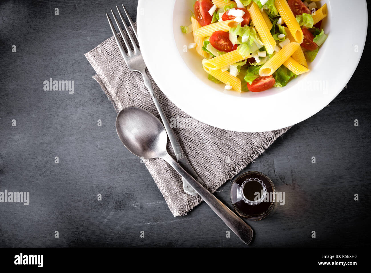 Pasta salad with fresh greenery and tomatos Stock Photo - Alamy