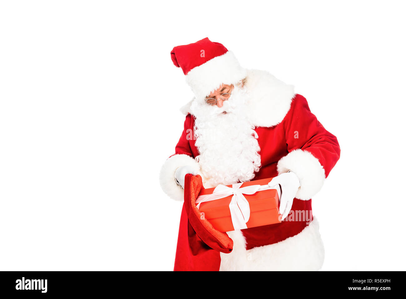 santa claus putting gift box into bag isolated on white Stock Photo - Alamy