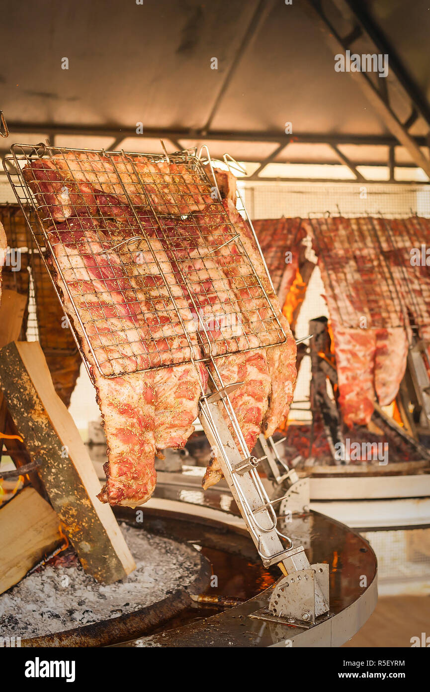 Roasted meat of beef cooked on a vertical grills Stock Photo - Alamy
