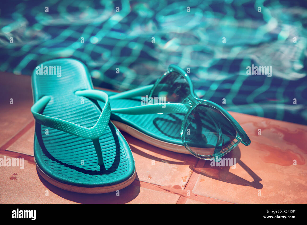 Blue slippers and sunglasses on border of a swimming pool - holiday ...