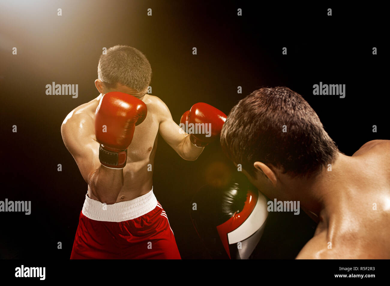 Two professional boxer boxing on black background Stock Photo - Alamy