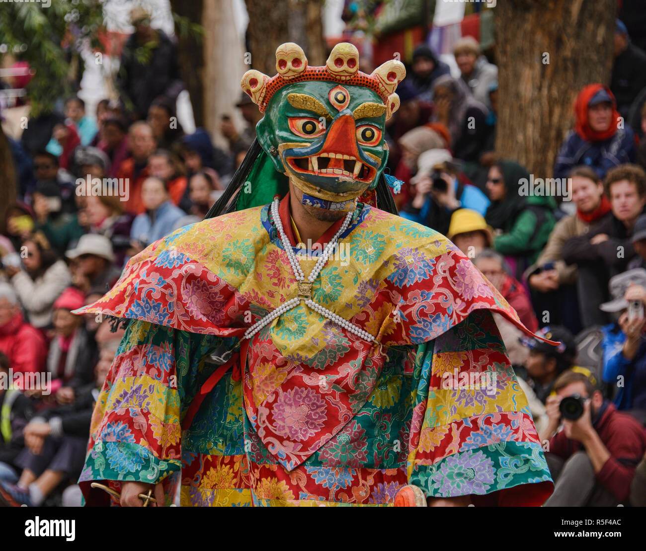 A masked monk performs at a traditional cham Tibetan Buddhist dance ...