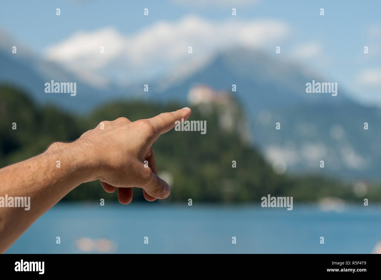 male hand showing destination on the mountain Stock Photo - Alamy