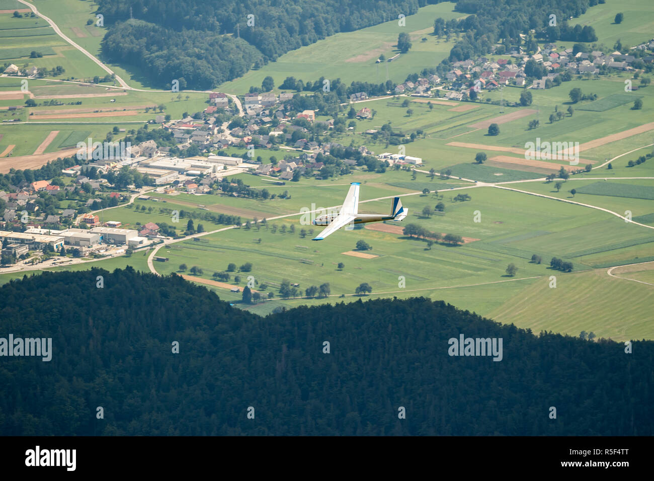 glider flying over forest Stock Photo - Alamy