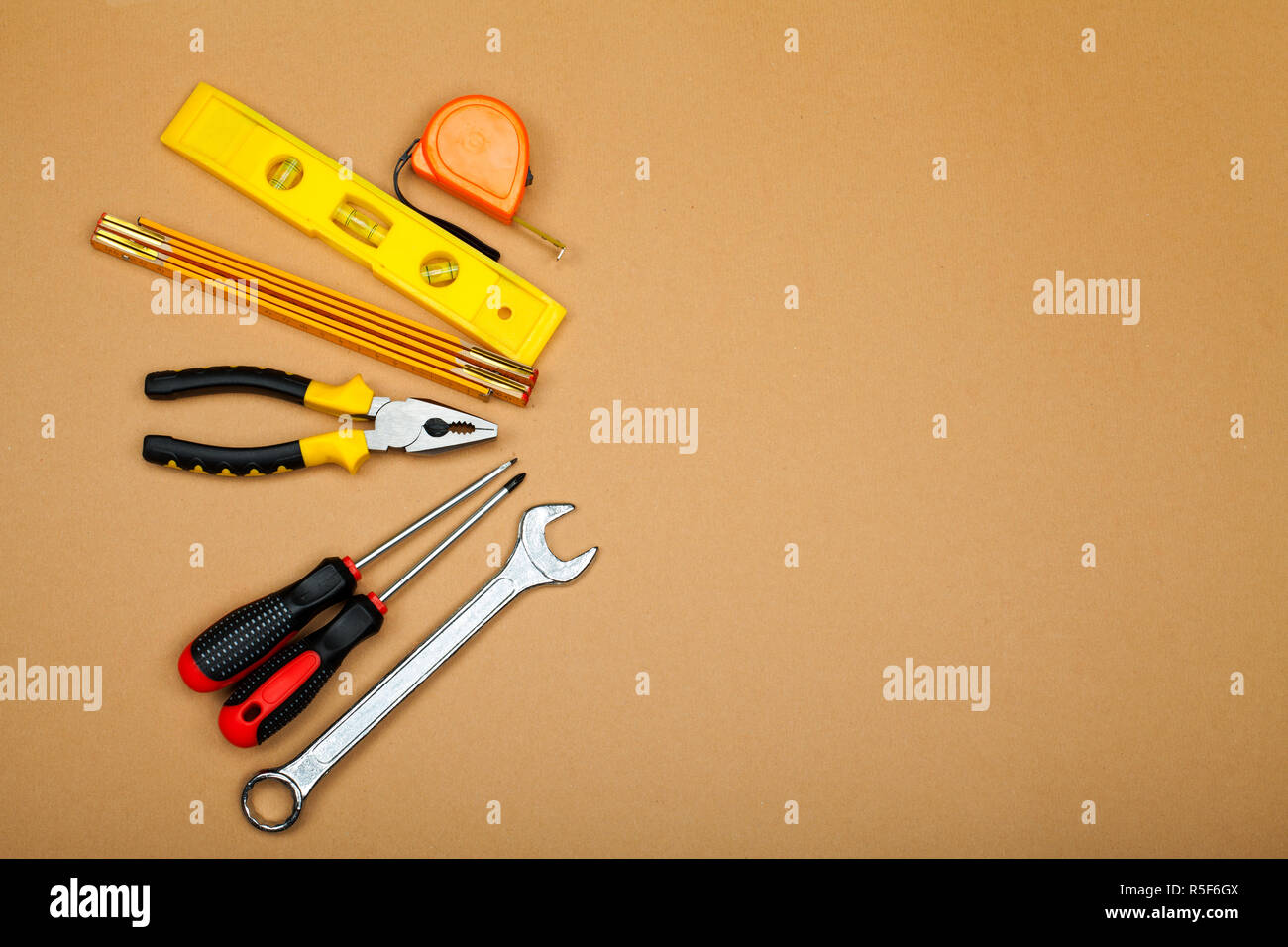 Construction equipment, tools on gradual orange background Stock Photo ...