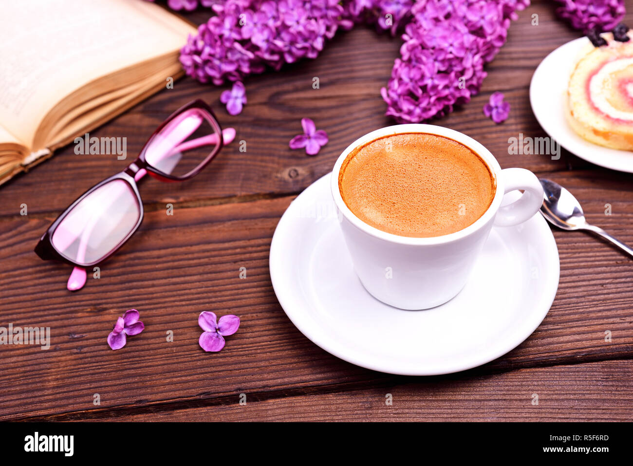 cup of espresso, behind an open book Stock Photo - Alamy