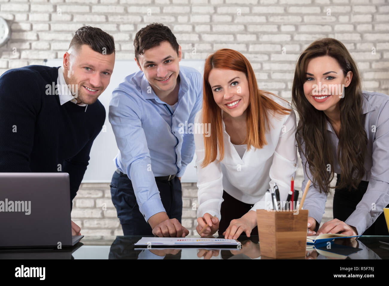 Happy Business People Doing Work At Workplace Stock Photo - Alamy