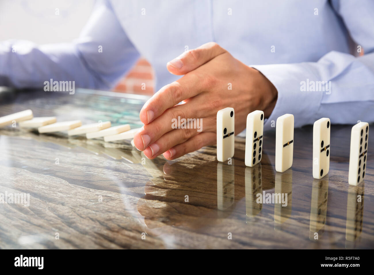 Business man protect falling blocks hi-res stock photography and images ...