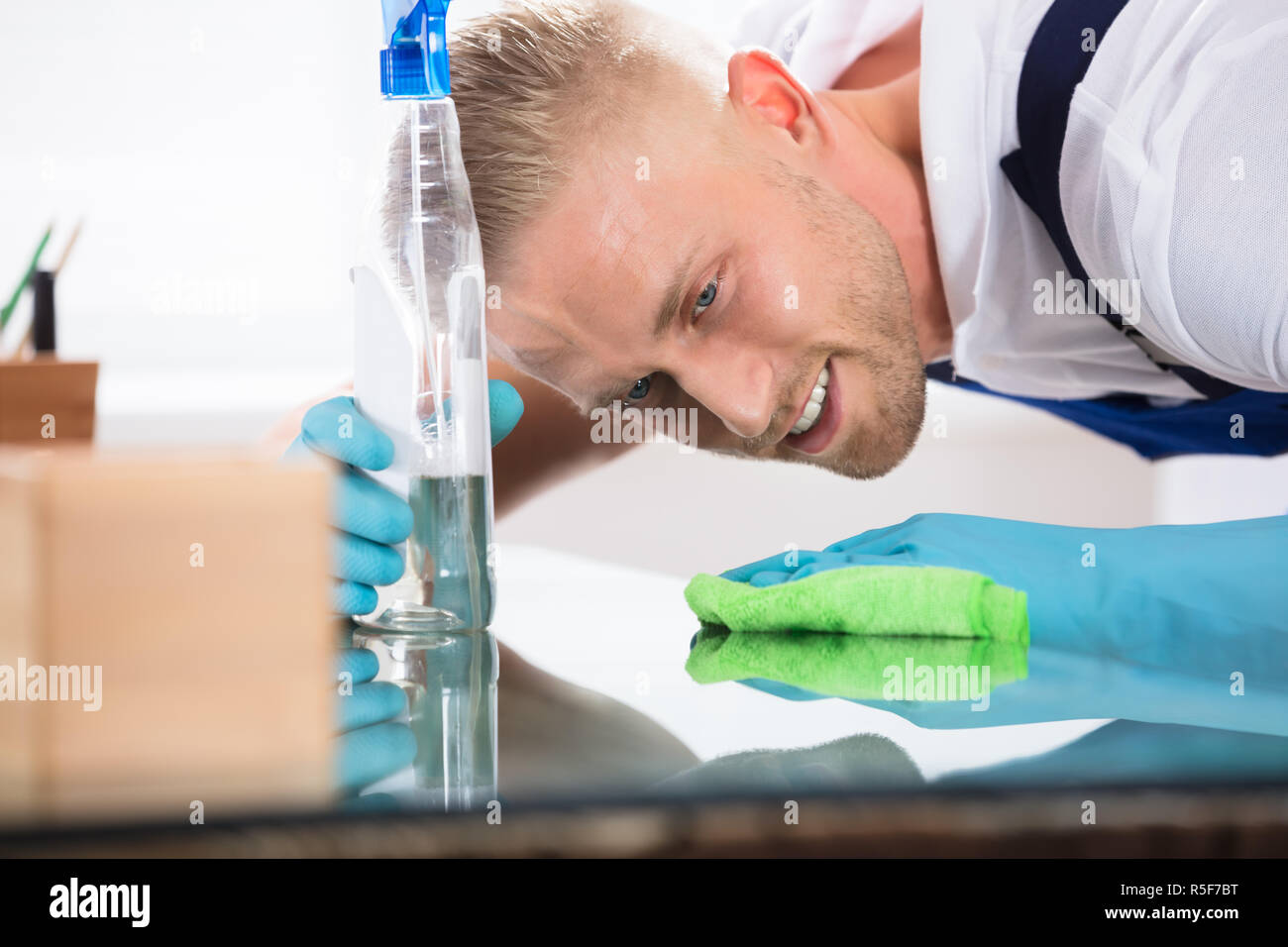 Close-up Of A Janitor Cleaning Desk With Cloth Stock Photo - Alamy