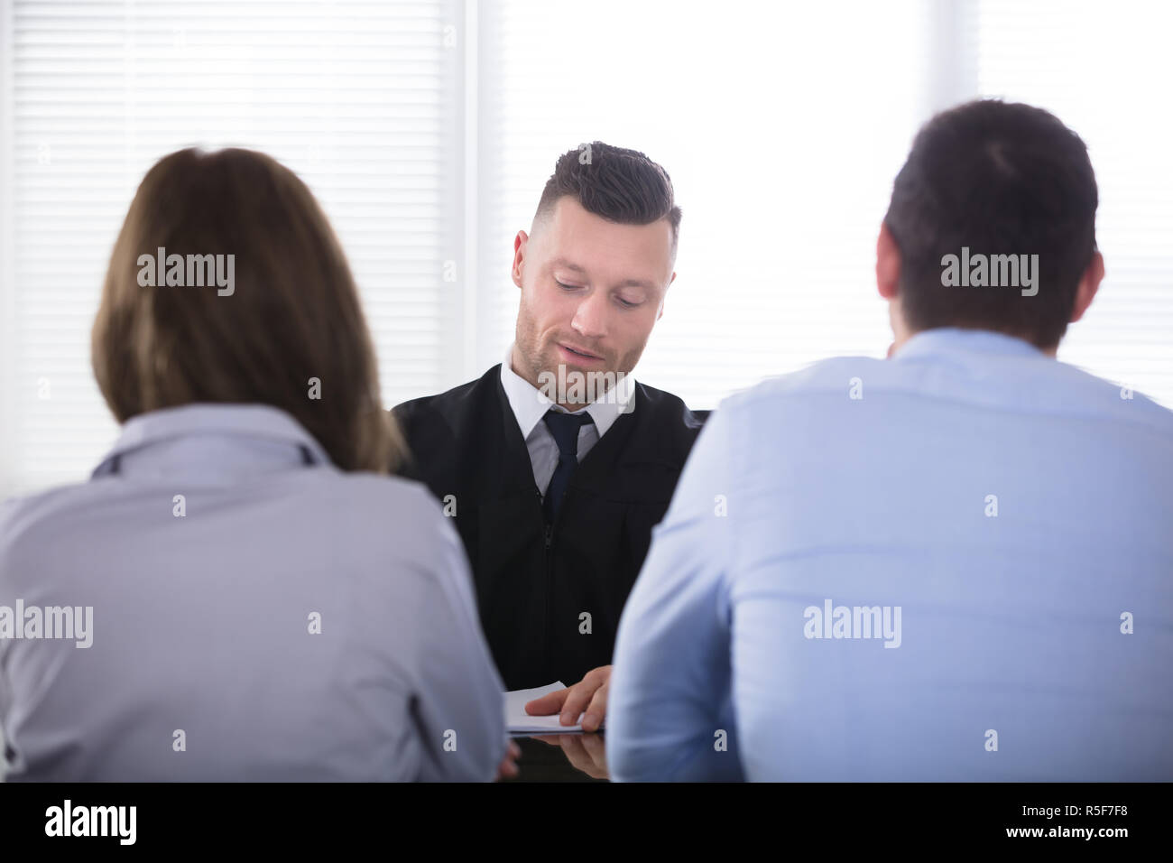 Couple Sitting In Front Of Judge Stock Photo - Alamy