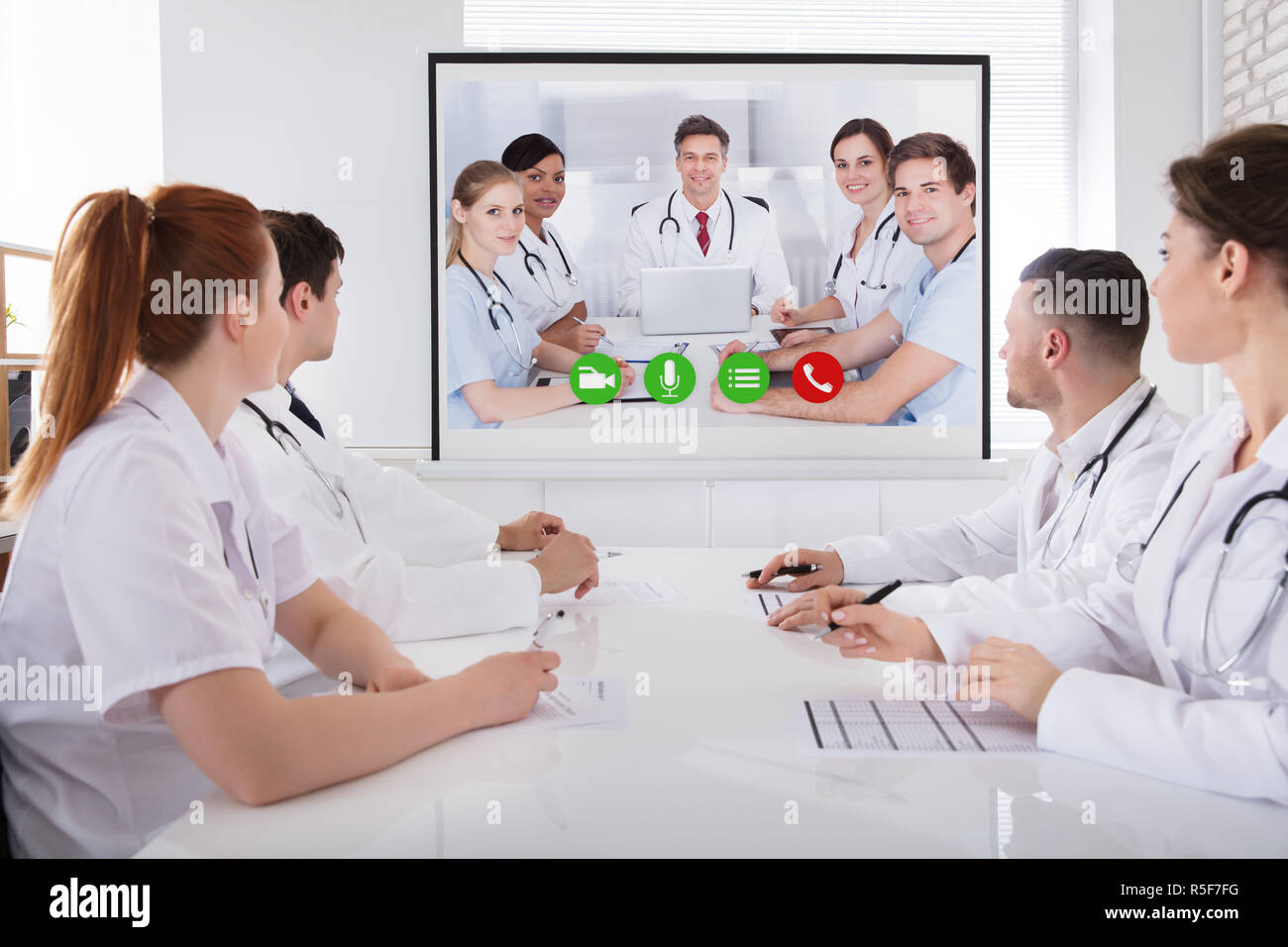 Doctors having online video conference hi-res stock photography and ...