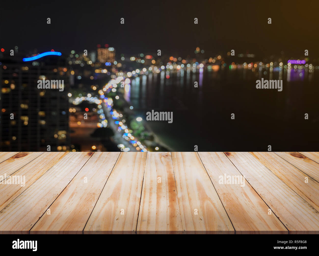 Empty wooden table with blurred city skyline background at night Stock ...