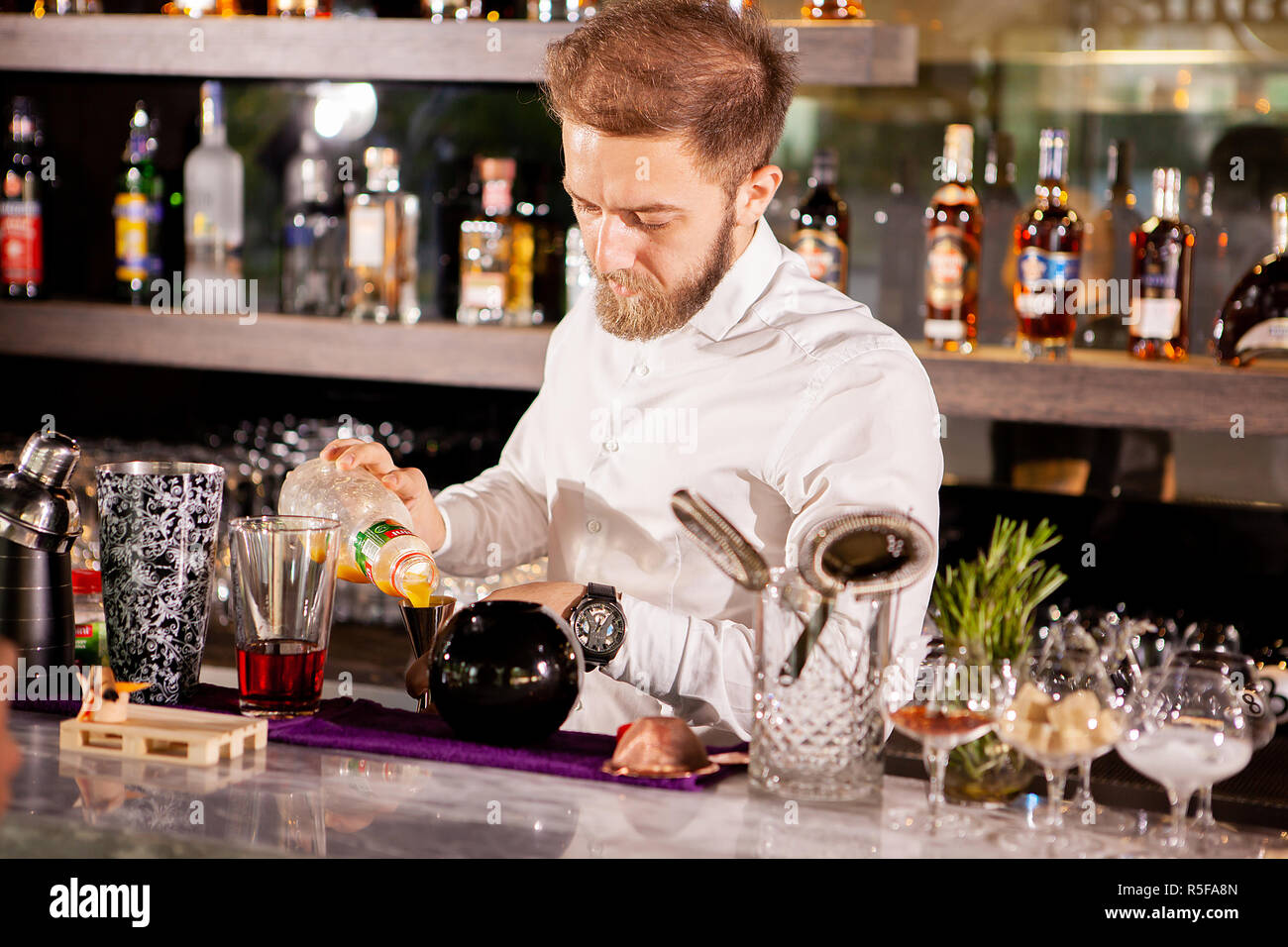 Closeup of bartender hands pouring alcoholic drink.Professional drink ...