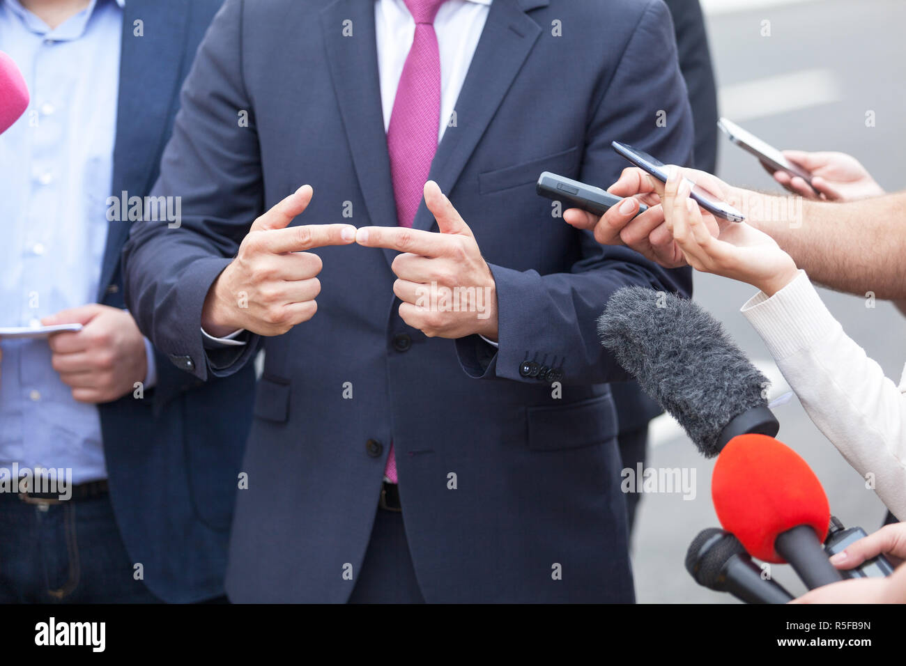 Media interview. Hand gesture Stock Photo - Alamy