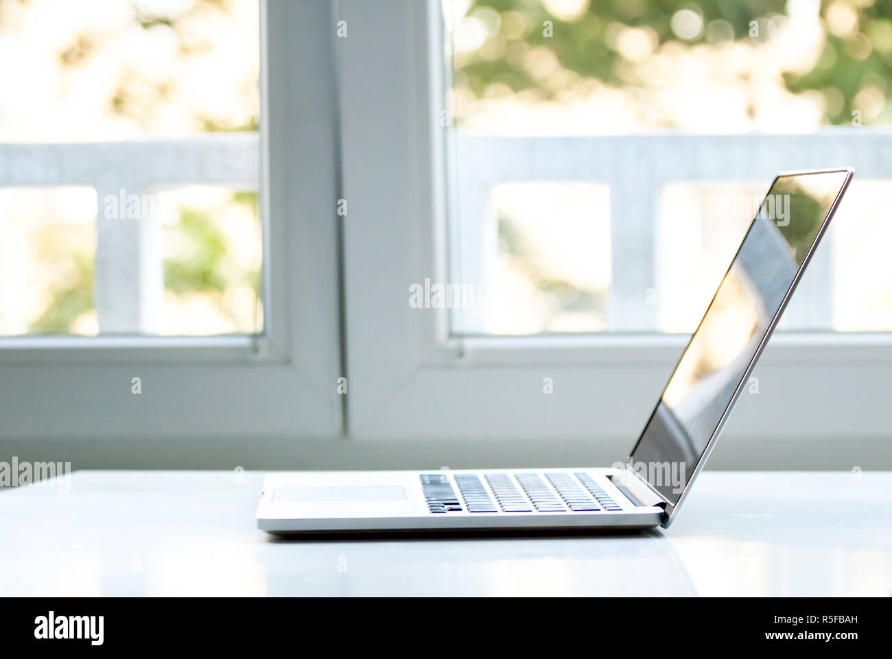 laptop computer near the window Stock Photo - Alamy