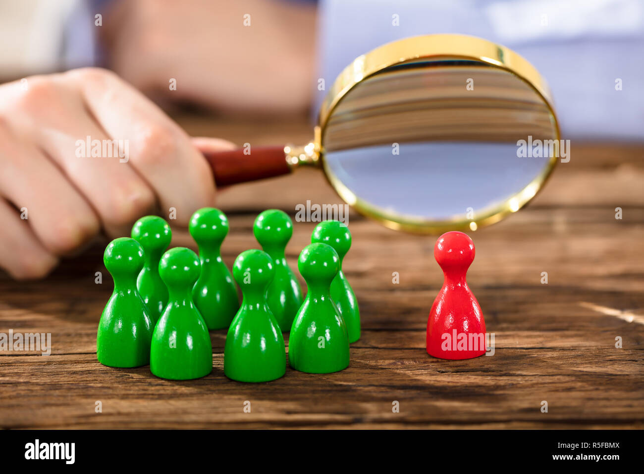 Human Hand Examining Red Plastic Figure With Magnifying Glass Stock ...