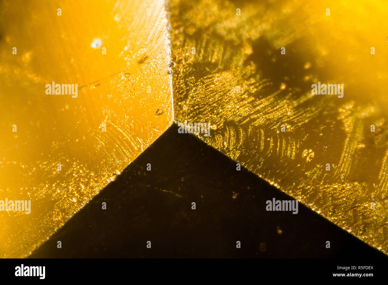 Yellow gem under the microscope Stock Photo - Alamy