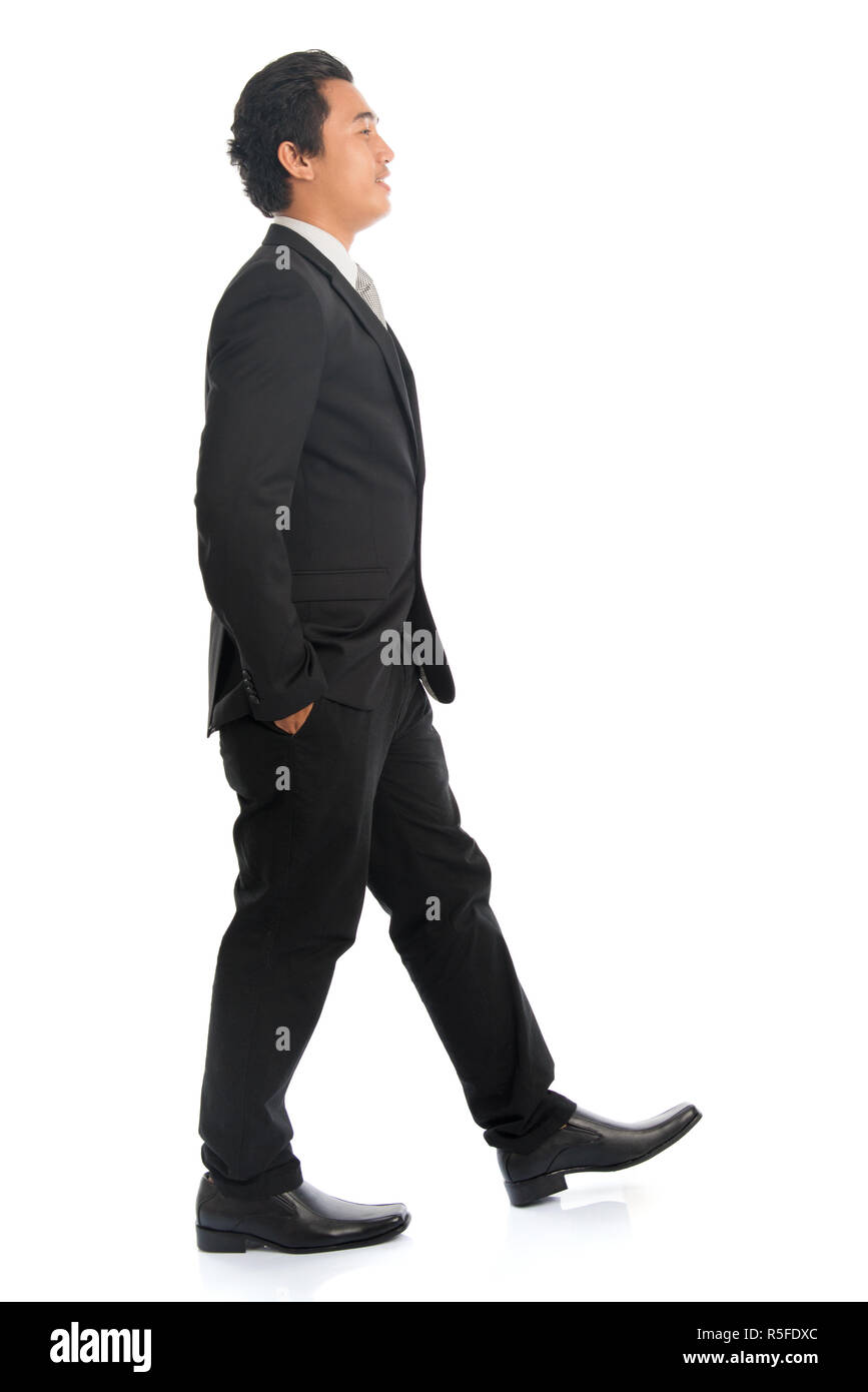 Side view Asian man walking Stock Photo - Alamy